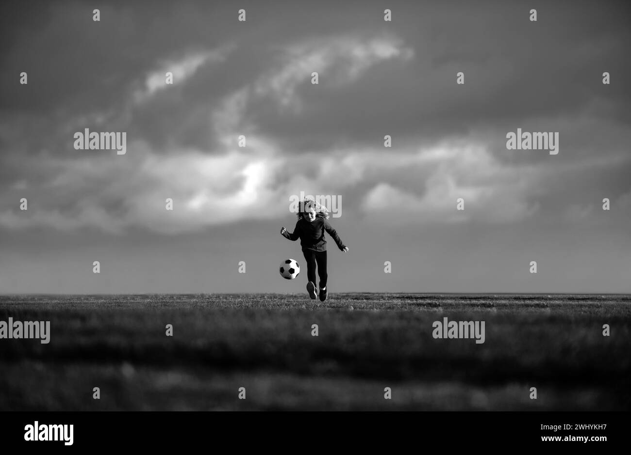 Young soccer player in sportswear with soccer ball. Cheerful little boy ...