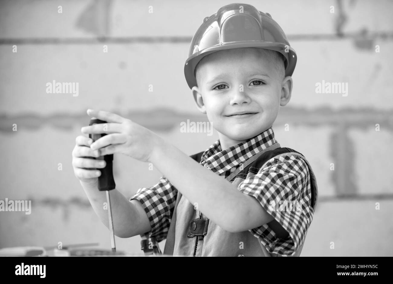 Child in building helmet, hard hat. Child dressed as a workman builder ...