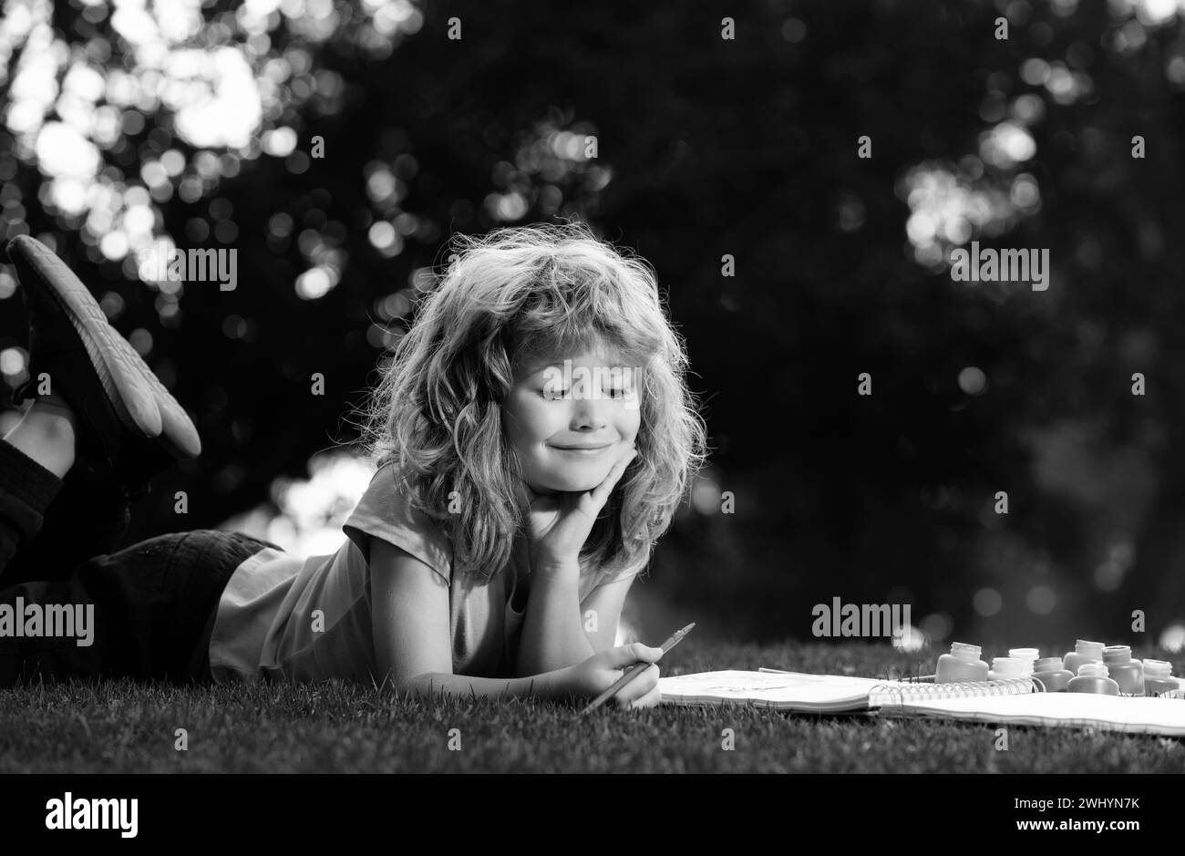 Child drawing. Kids painting with paints color and brush in park ...
