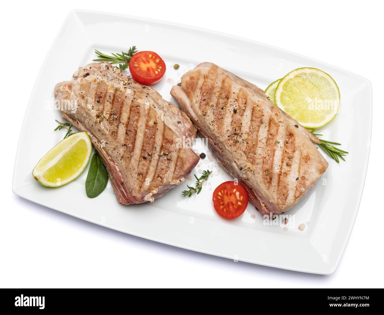 grilled cooked piece of tuna fillet on ceramic plate isolated on white ...