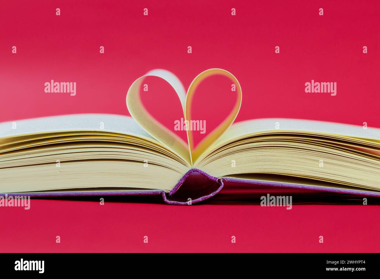 Pages of a book curved into a heart shape. Opened book, pages shaped to ...