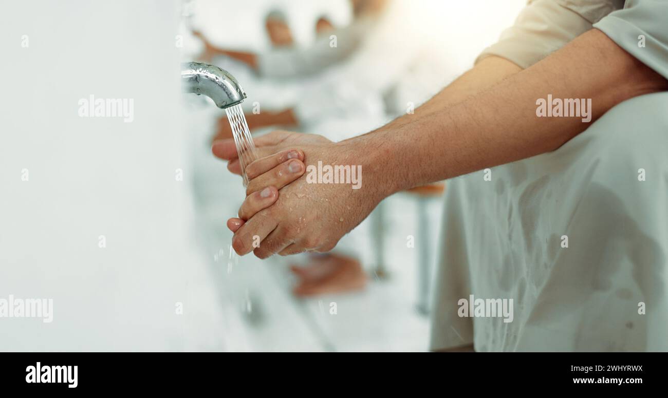 Muslim, community and person washing hands with holy water after ...
