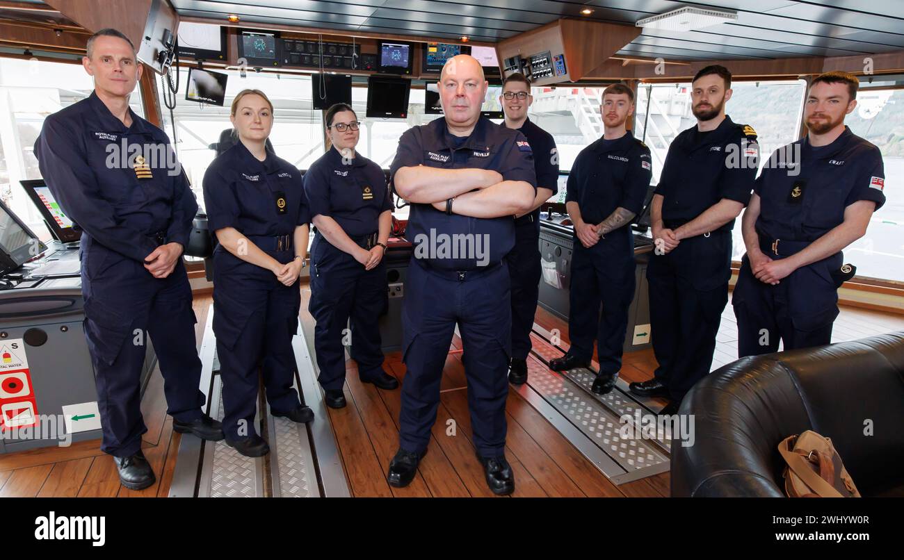 Commanding Officer Richard Reville (centre) with his crew, during a ...