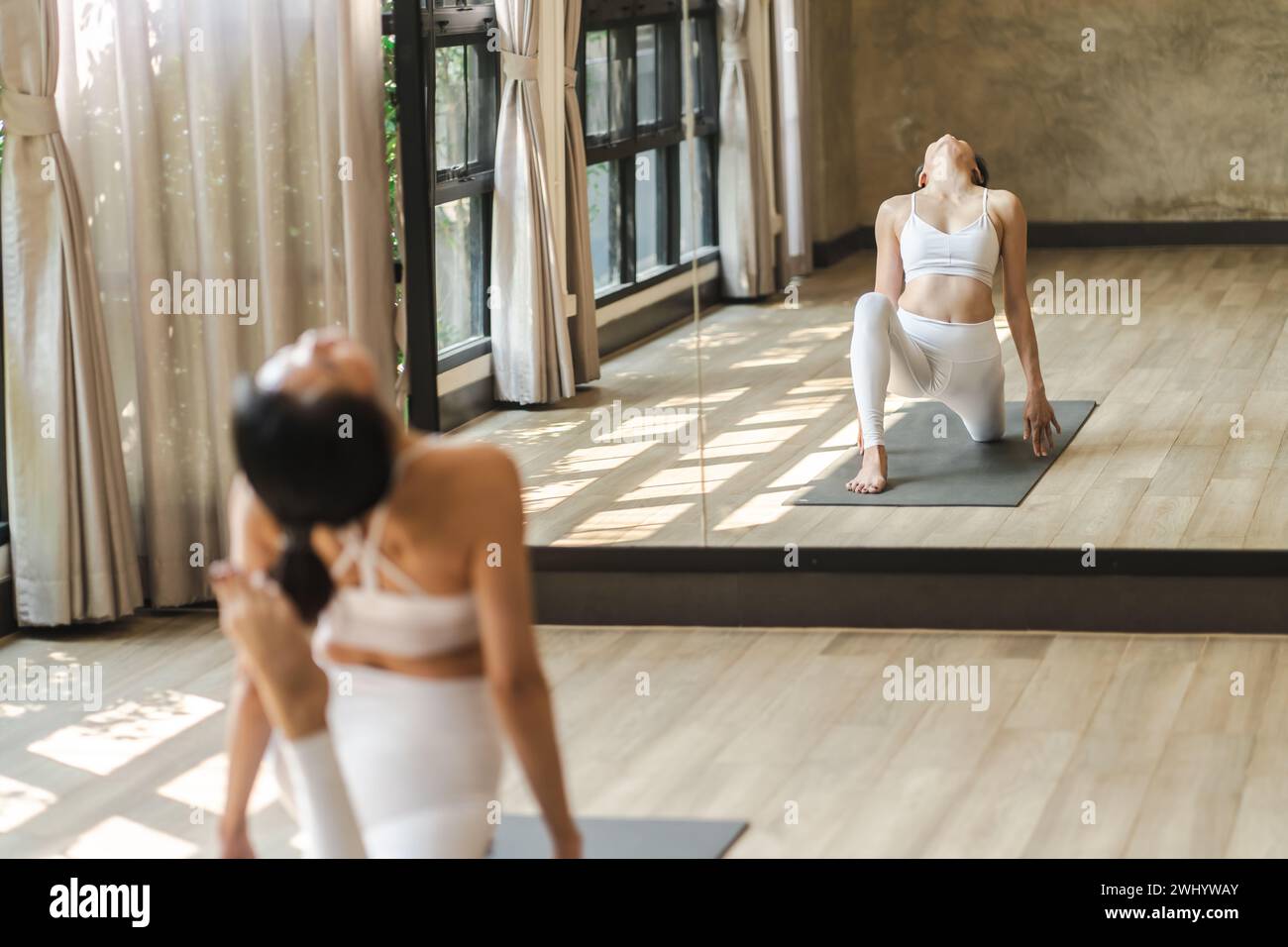 Fitness asian woman doing yoga stretching exercise on mat yoga fitness ...