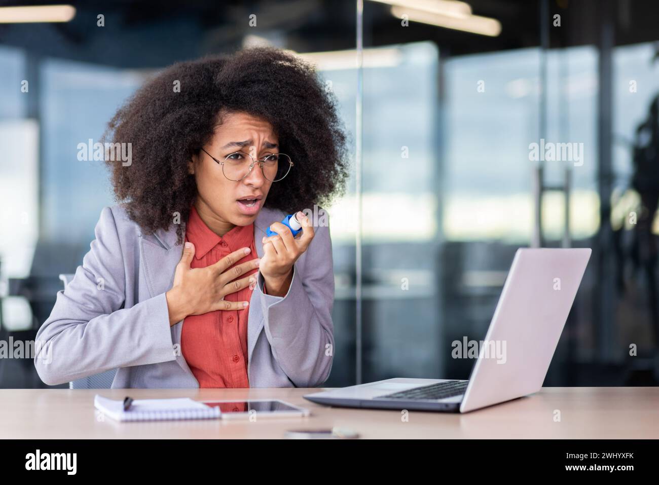 Asmathic executive director keeping hand on chest and opening mouth for ...