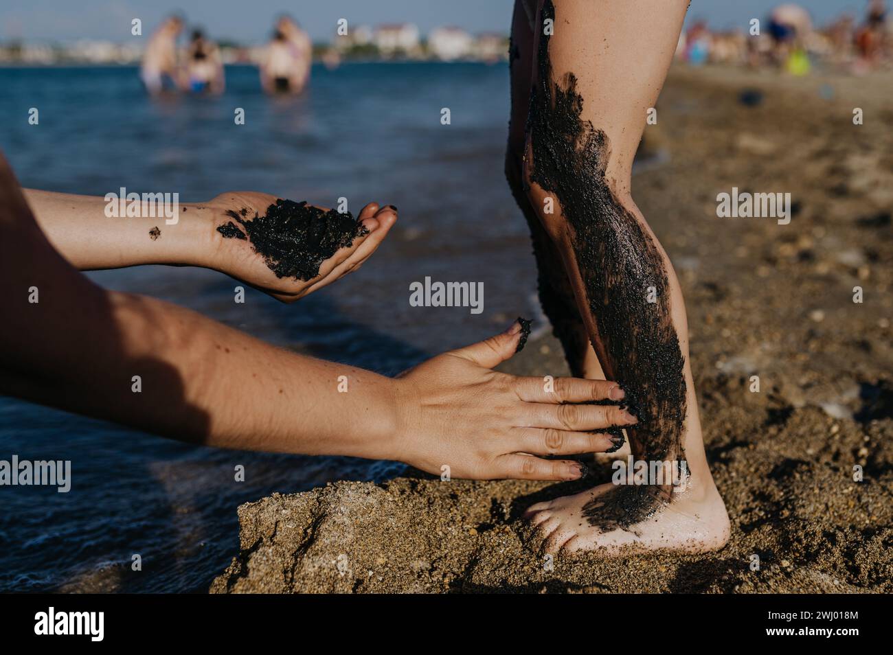 Mother applies healing mud to kids skin. Natural healing mud in Croatia ...