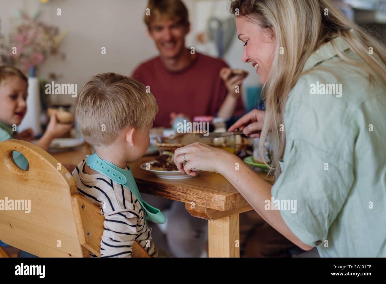 Family eating breakfast together in home kitchen. Healthy breakfast or ...