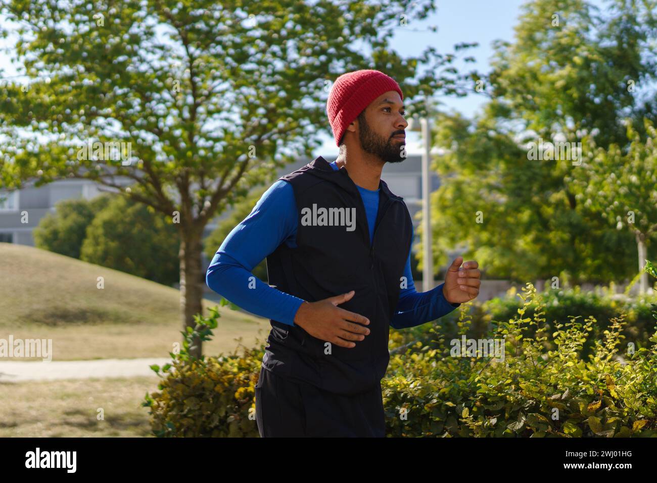 Man running outdoors. Exercising after work for good mental health ...
