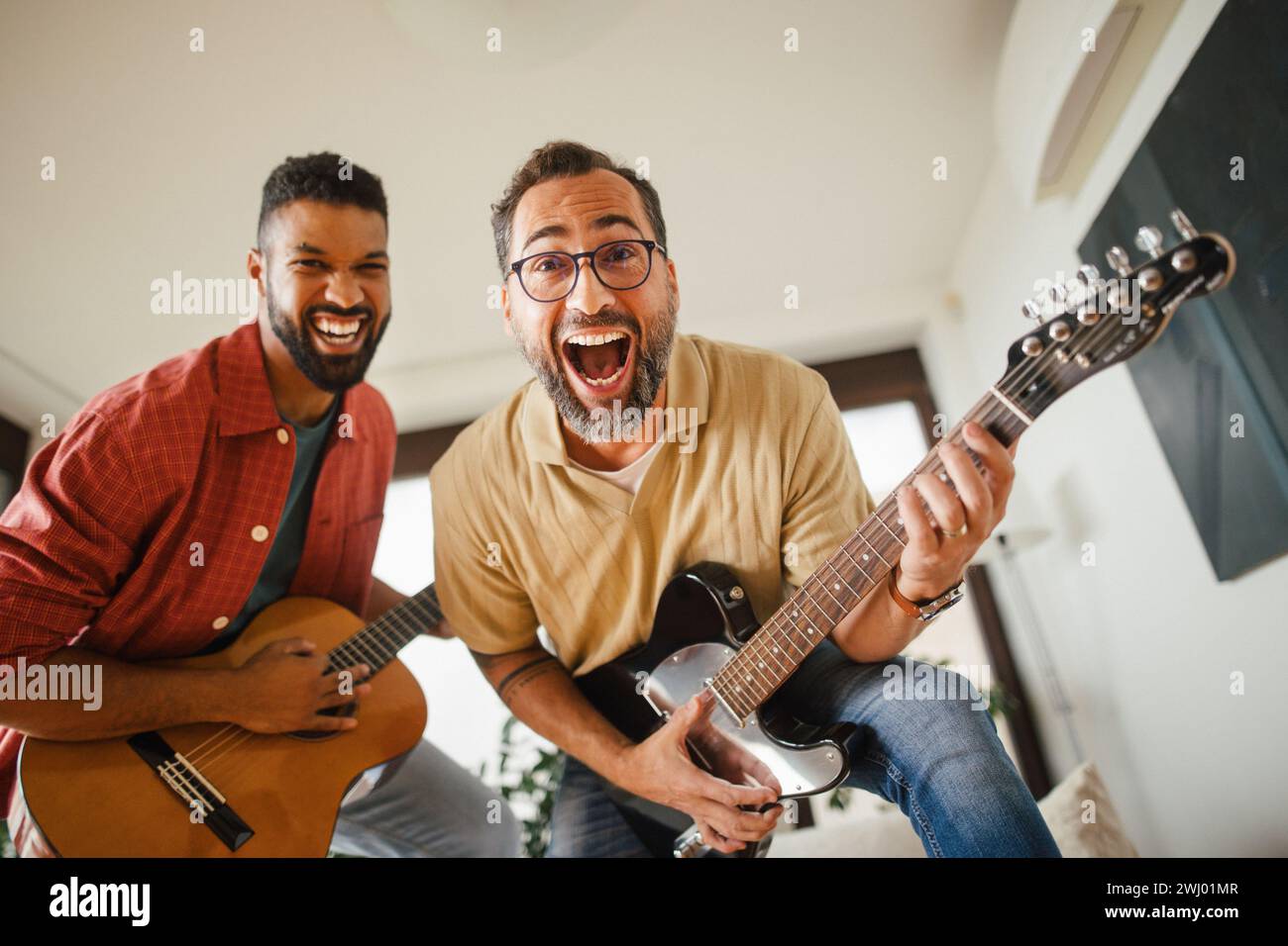 Best friends, musician jamming together. Playing music on guitar ...