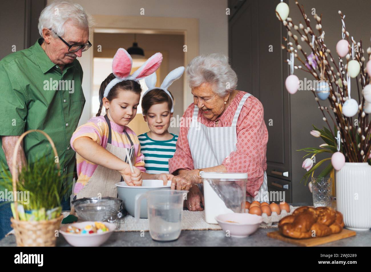 Grandparents with grandchildren preparing traditional easter meals ...