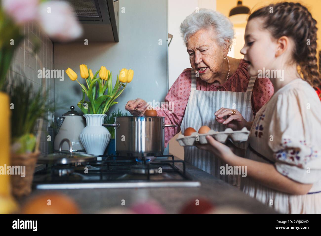 Grandmother with grandaughter preparing traditional easter meals ...