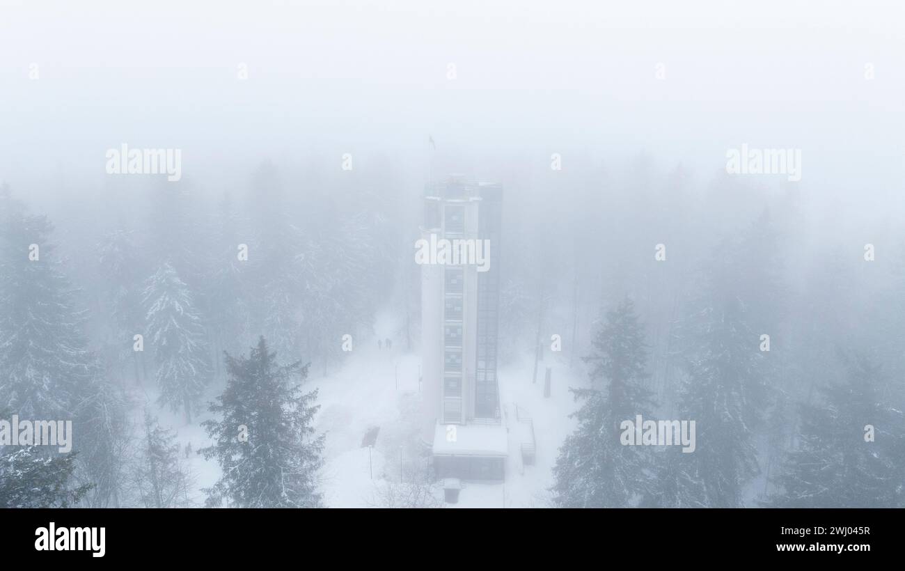 An aerial view of the wintertime snow-clad forested Suur-Munamagi hill ...