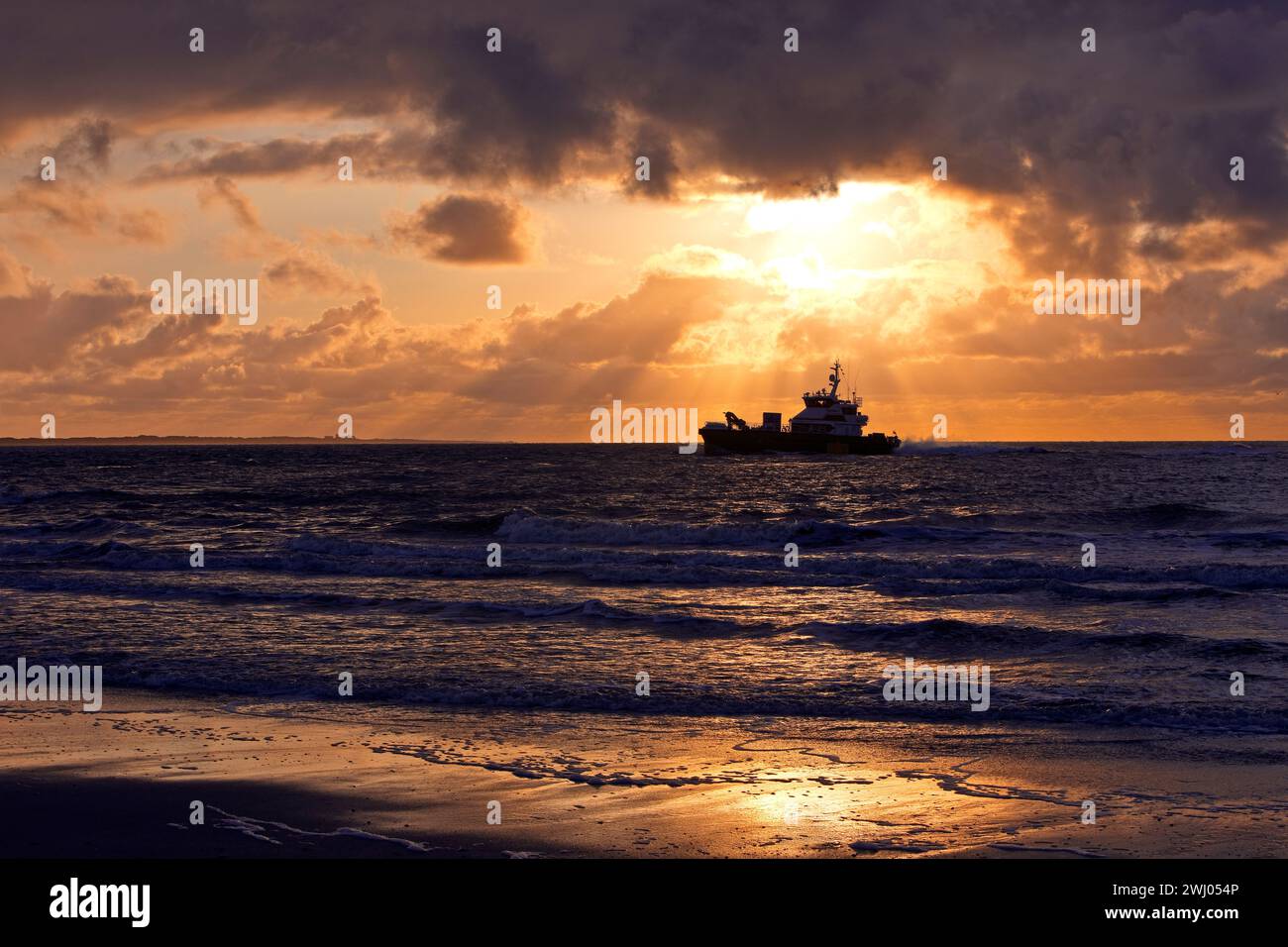 Sea at sunset with the offshore supply ship FARRA CLIONA, North Sea ...