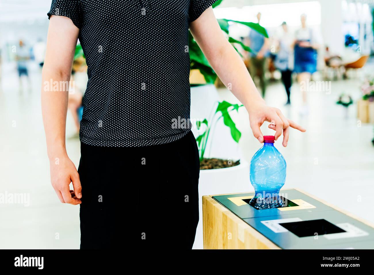 Close up hand throwing empty plastic water bottle into recycling bin, recycle rubbish Stock ...