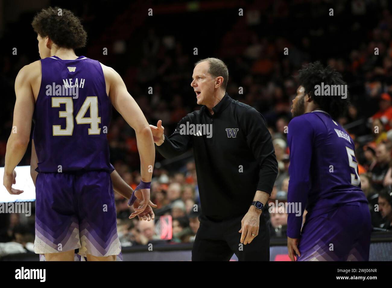 Washington head coach Mike Hopkins talks with center Braxton Meah (34 ...