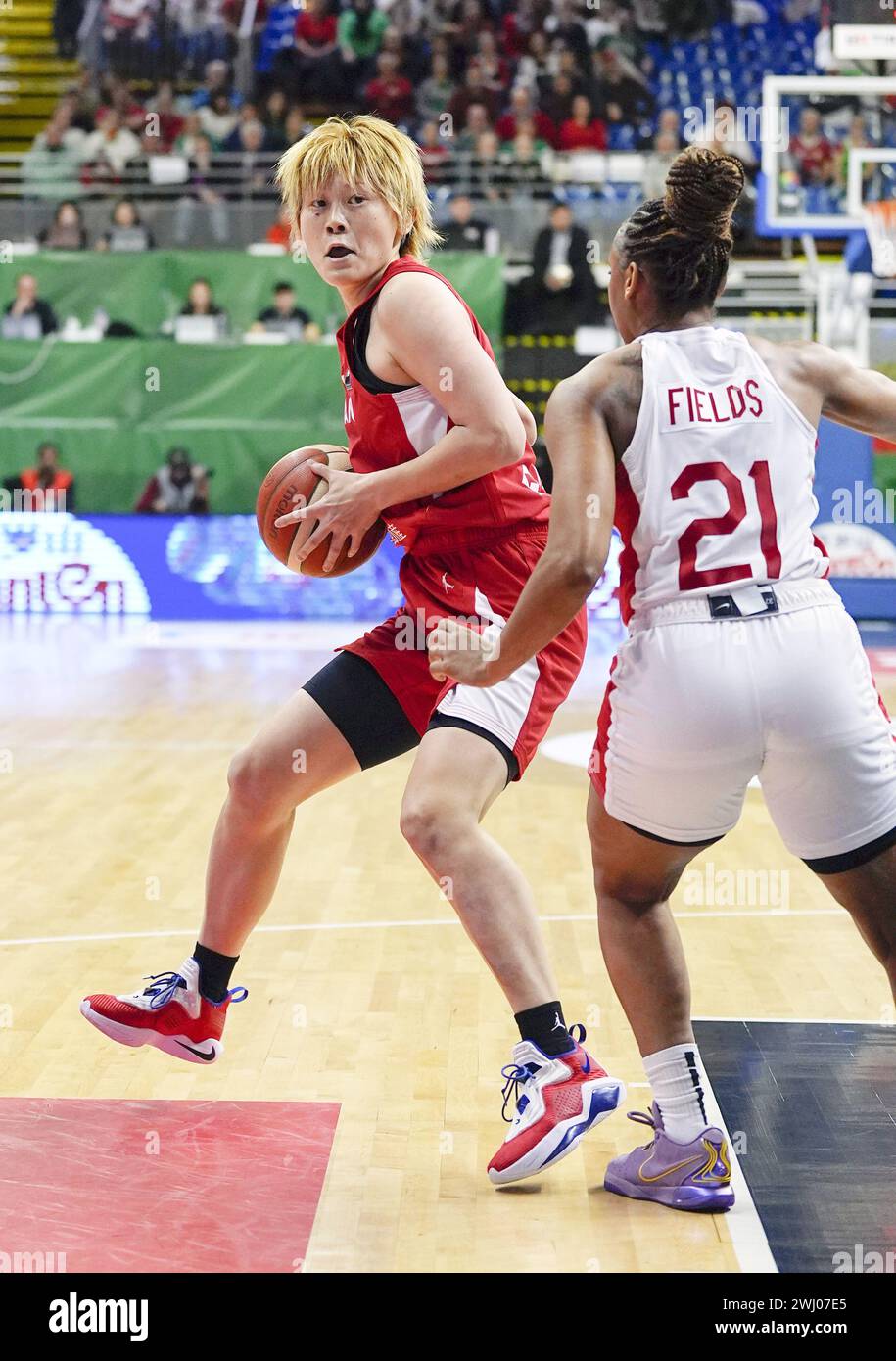 Japan's Maki Takada (L) is in action while Canada's Nirra Fields plays defense in the first ...