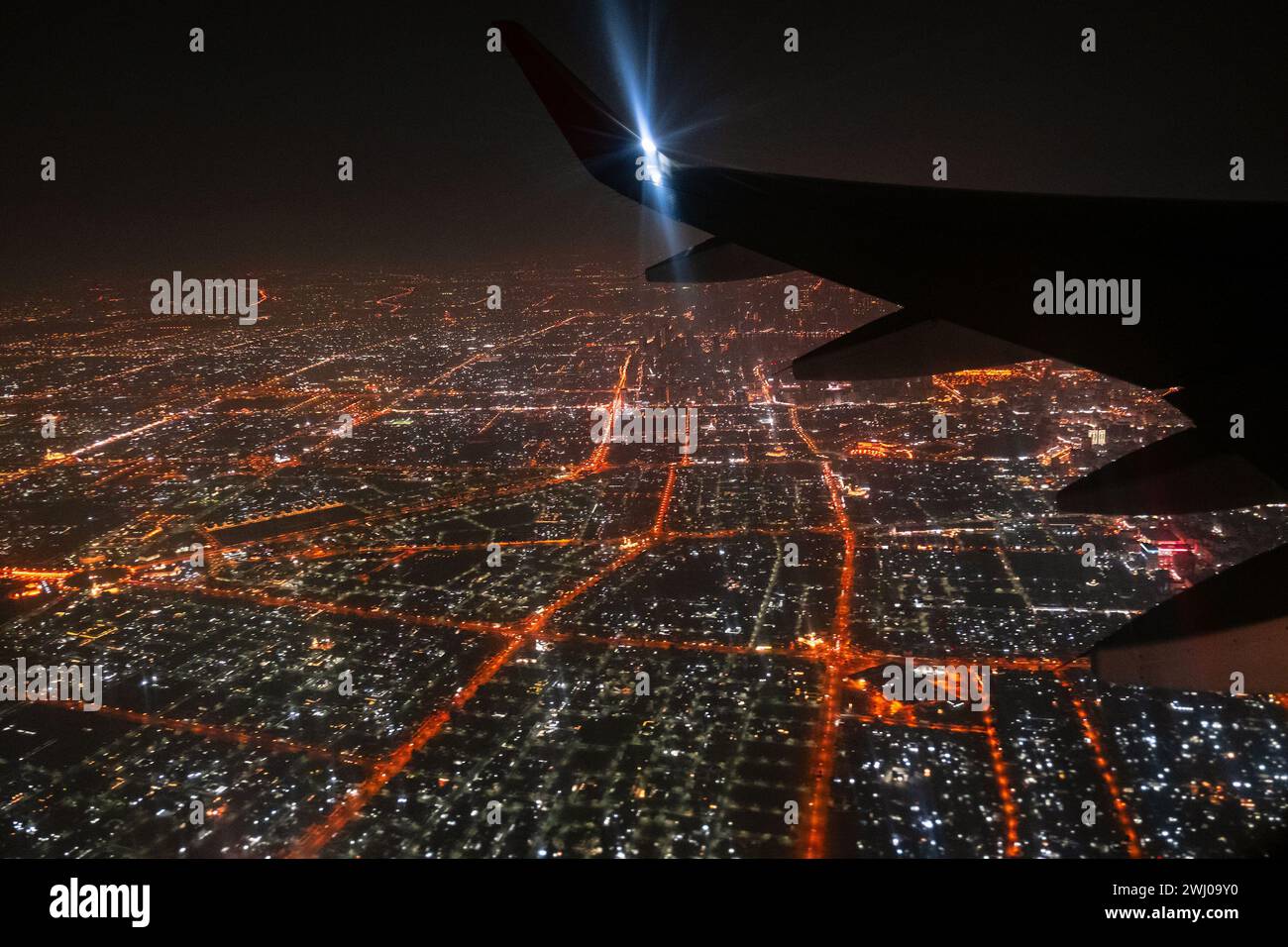 View of the night city through an airplane window Stock Photo - Alamy