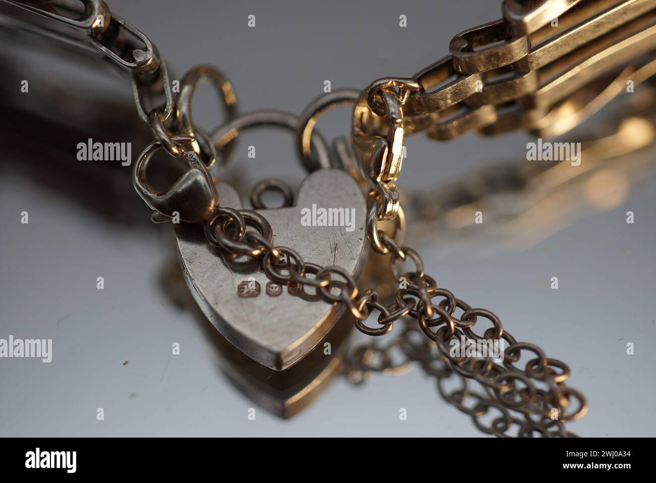 Assorted keys and a heart-shaped lock connected by a chain Stock Photo ...