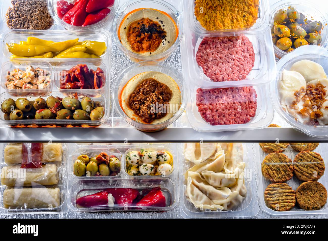 A display of variety of prepackaged food products in plastic boxes ...