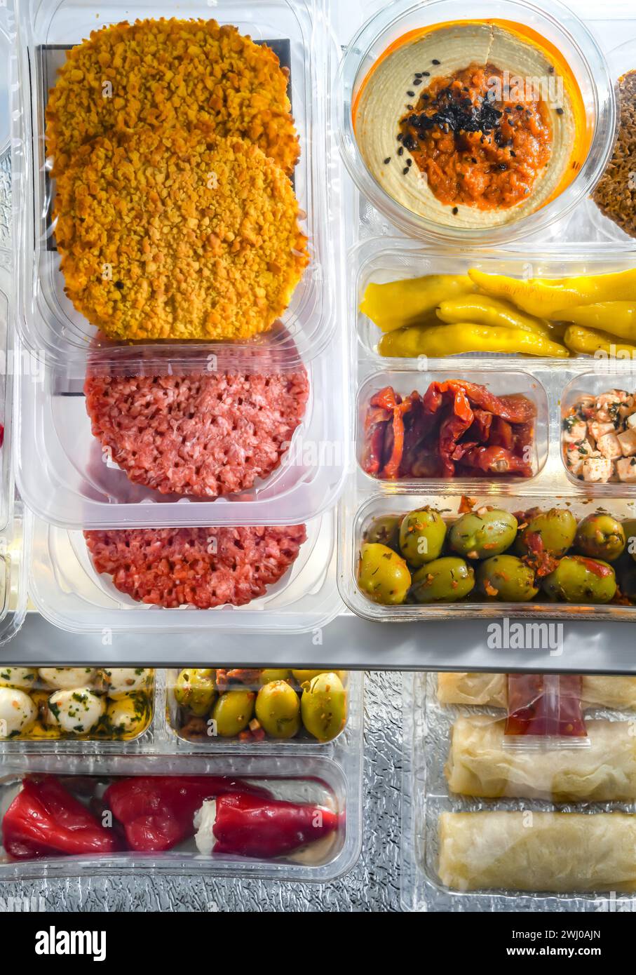A display of variety of prepackaged food products in plastic boxes ...