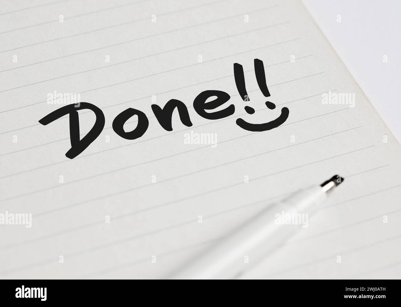 Job done message handwritten on a notebook with pen Stock Photo - Alamy