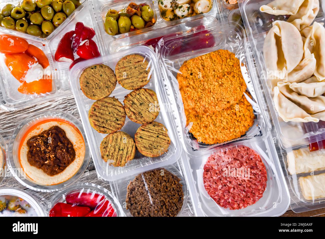 A display of variety of prepackaged food products in plastic boxes ...