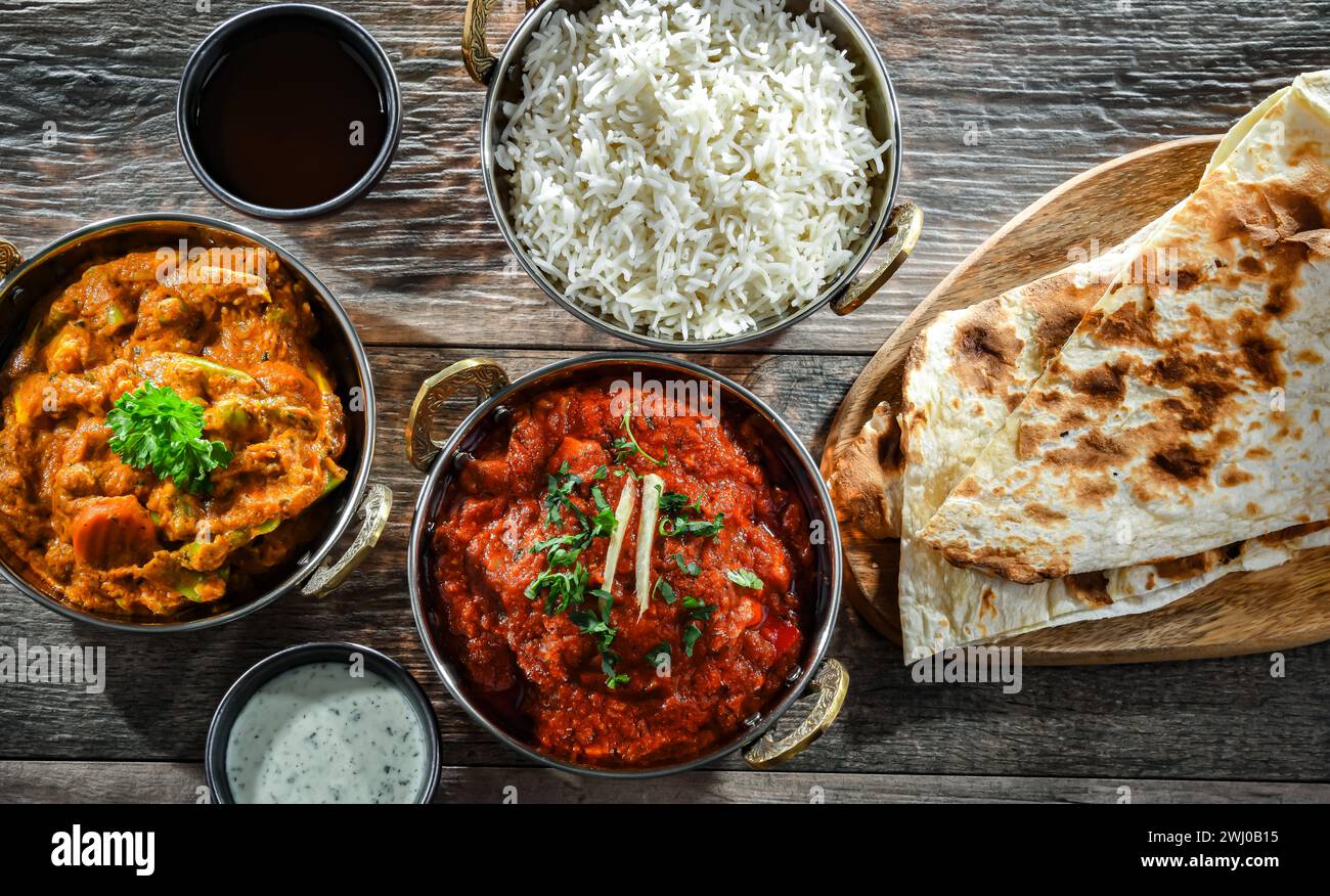 Hot madras paneer and vegetable masala with basmati rice served in ...