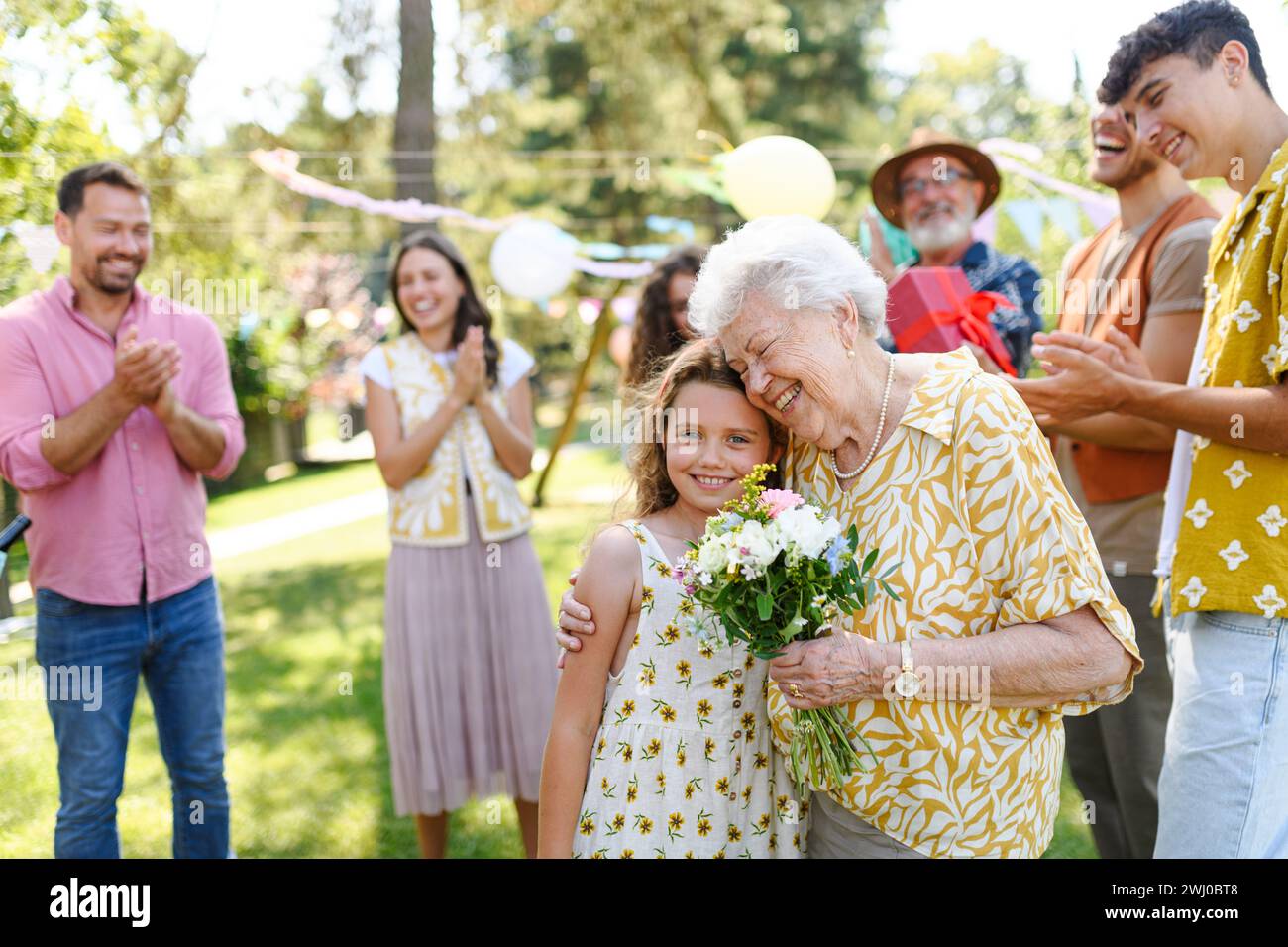 Beautiful Senior Birthday Woman Receiving Flowers From Granddaughter
