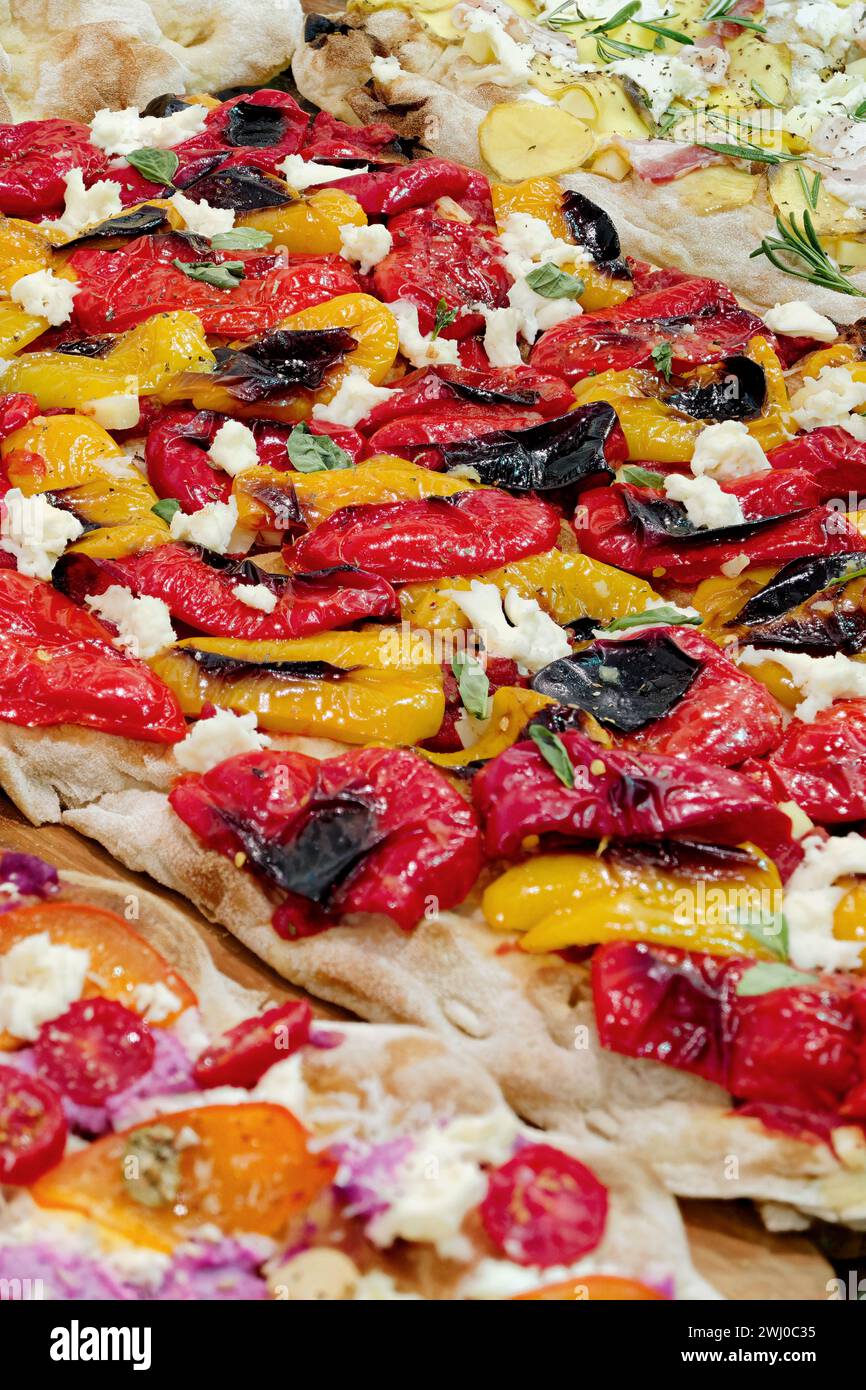 Traditional pizza with yellow and red peppers, tomatoes and mozzarella ...