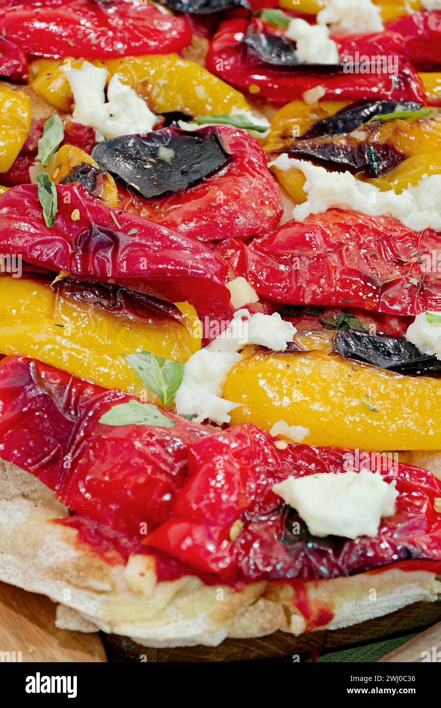 Traditional pizza with yellow and red peppers, tomatoes and mozzarella ...