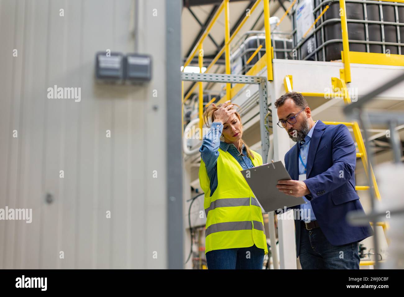 Supervisor, manager scolding employee in modern industry factory ...