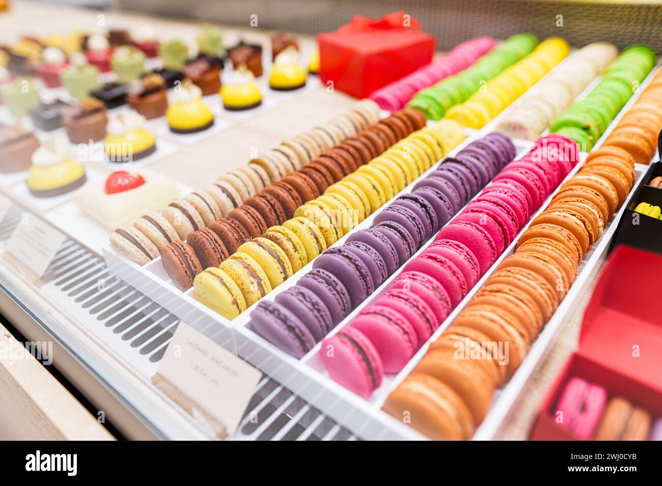Close-up view of colorful macarons and other sweets on counter display ...