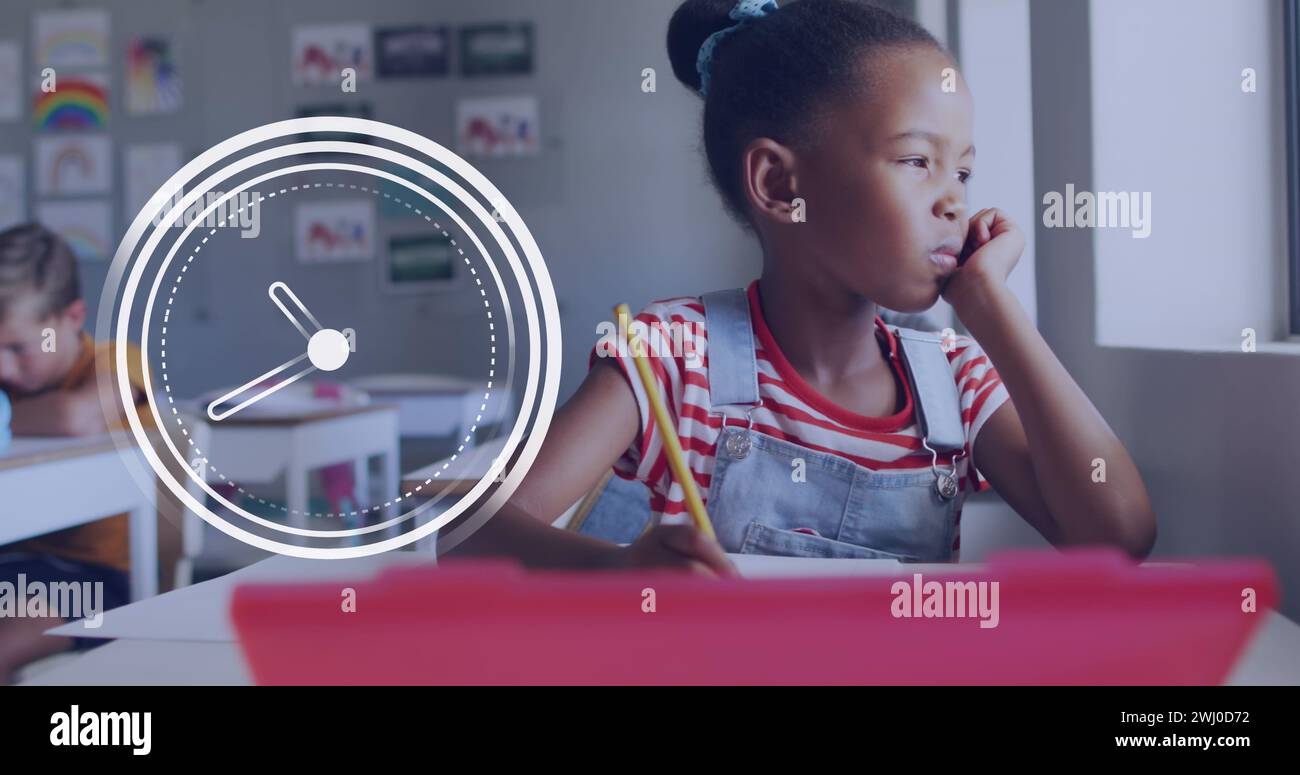 Image of clock over bored african american schoolgirl working at desk ...
