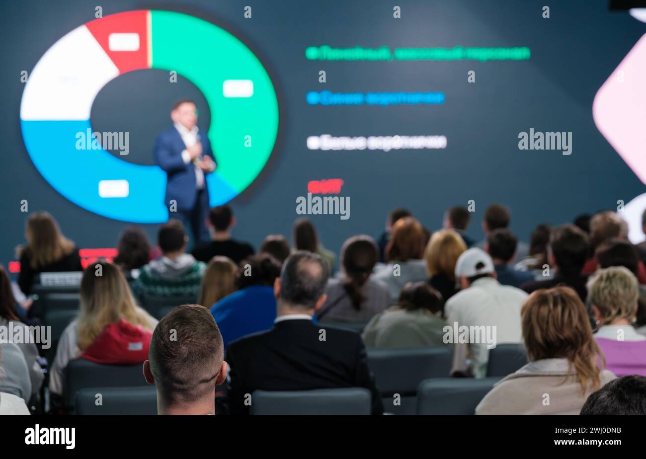 Focused audience at business conference watching a presentation with ...
