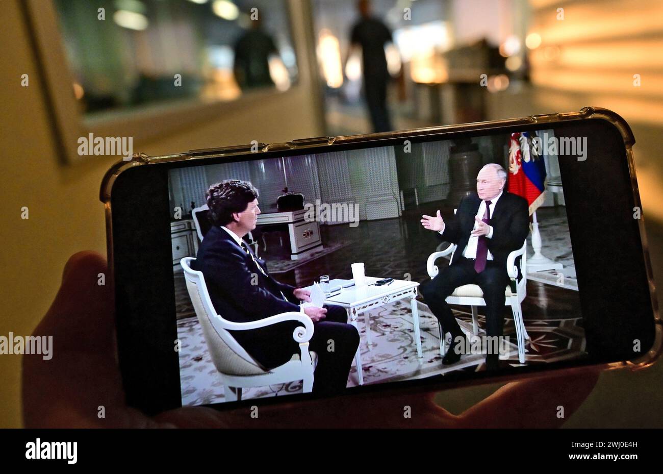 Genre photography. Broadcasting on a smartphone an interview of Russian President Vladimir Putin ...