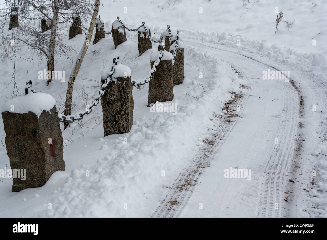 Small stone pillars with chains between Stock Photo - Alamy