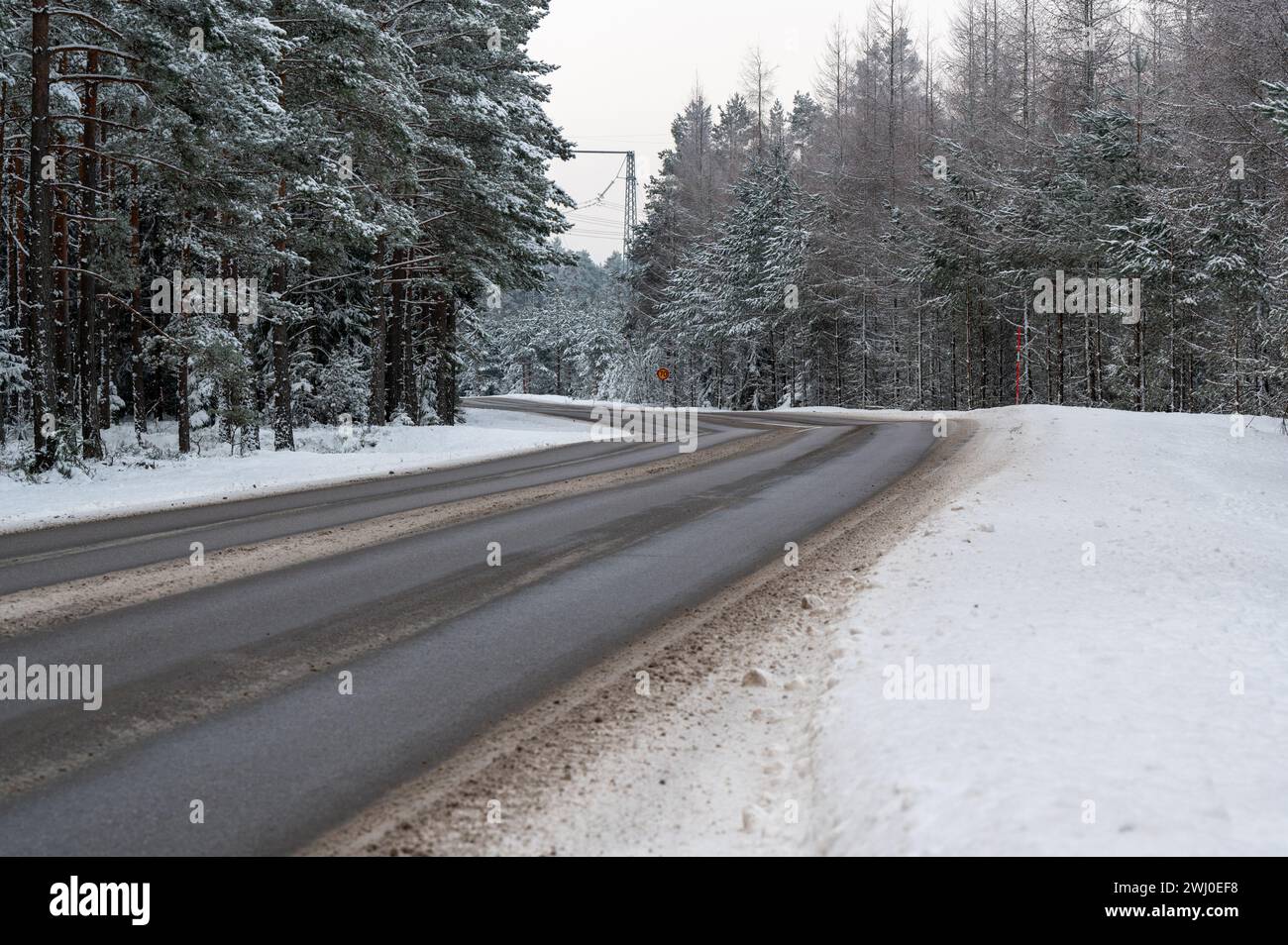 Winter road through forest in Hallsberg Sweden Stock Photo - Alamy