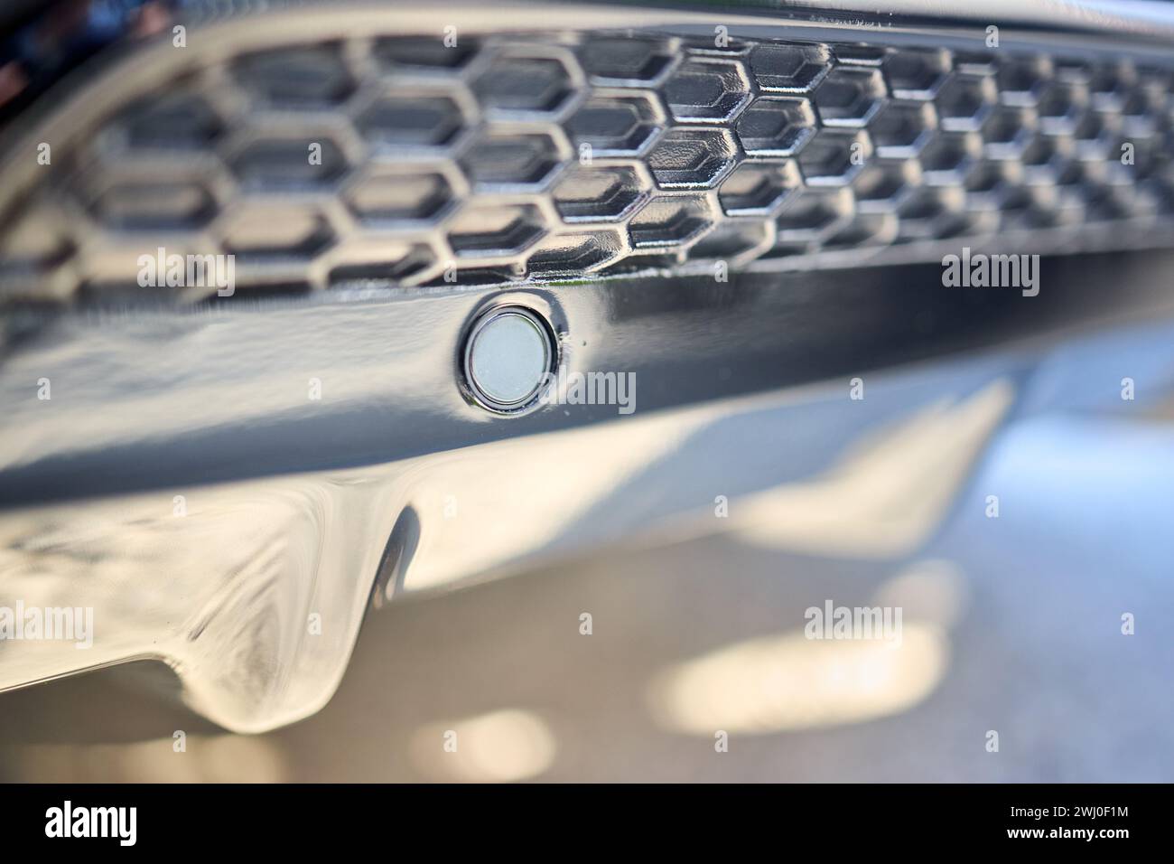 Selective focus on left side of rear bumper parking sensor at back of ...