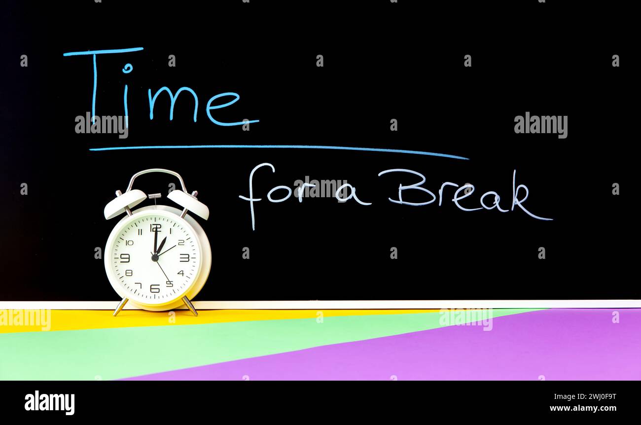 Time for a break drawing on a black chalkboard and a white clock at 13 ...