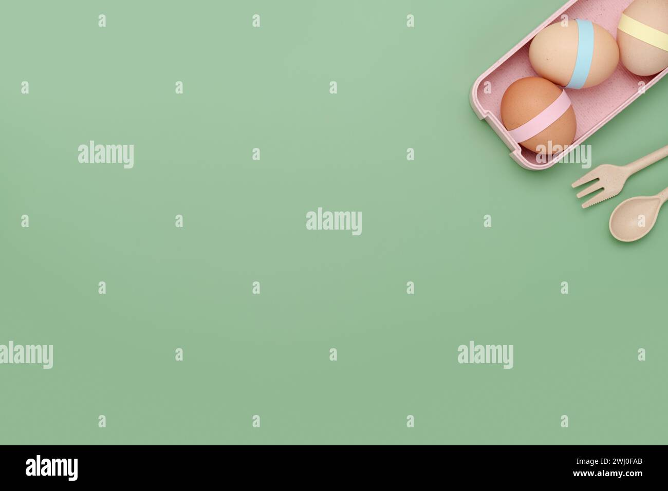 Decorated eggs in pink lunch box with cutlery empty background. Fun ...