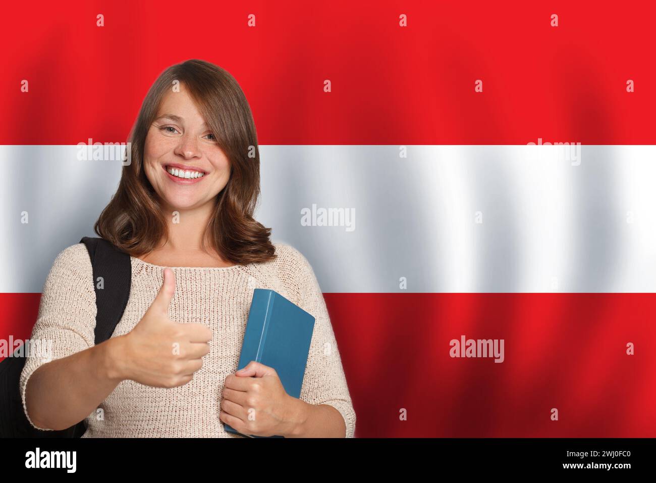 Happy woman student against Austrian flag background. Travel, education ...