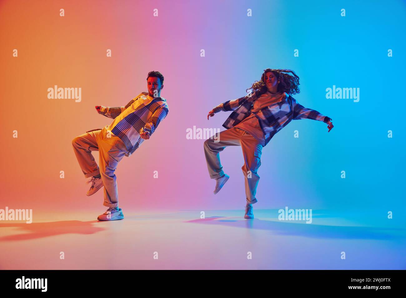 Dynamic photo of two dancers, man and woman move synchronously in hip ...