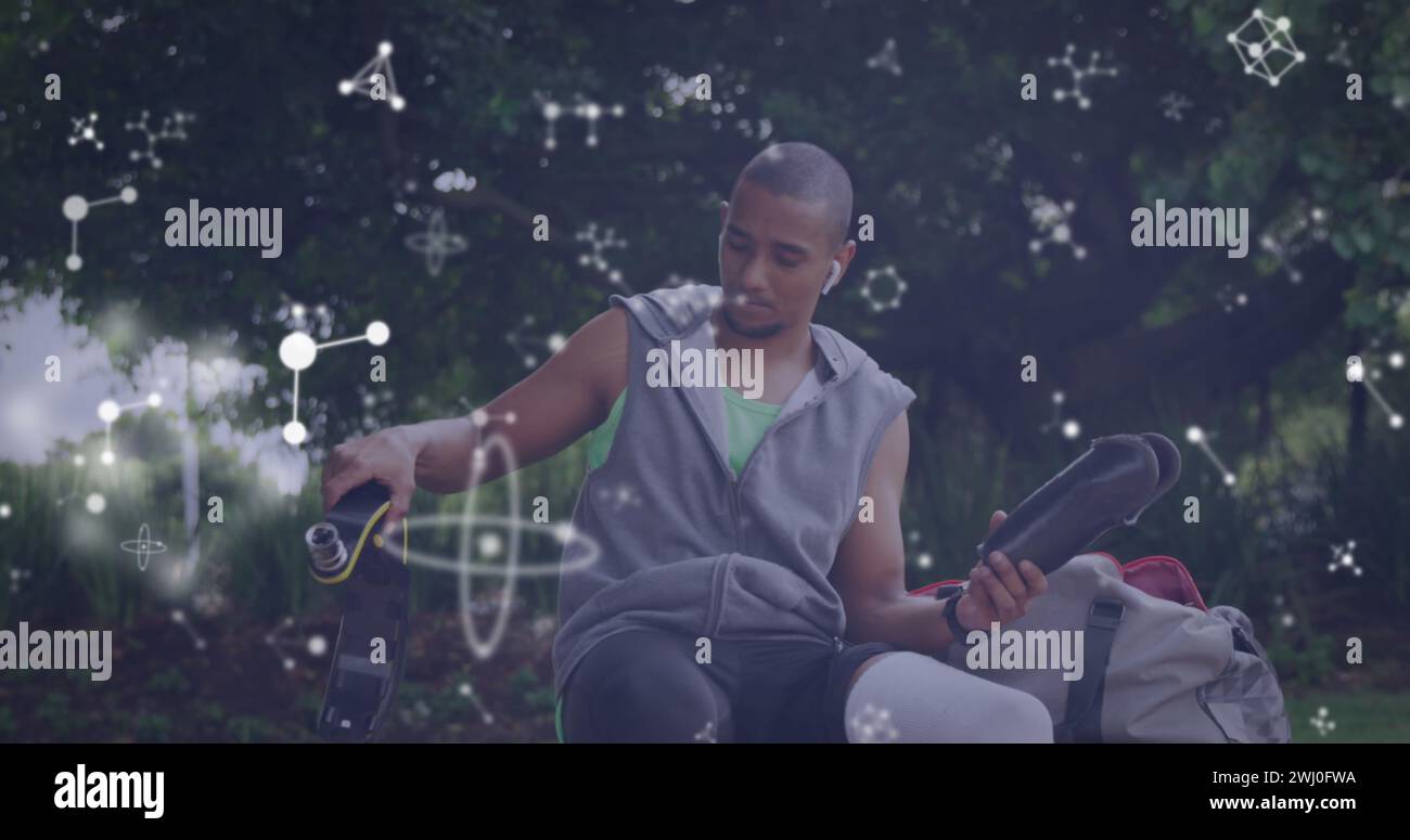 Image of communication networks over disabled male athlete attaching ...