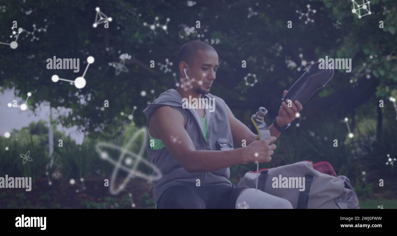 Image of communication networks over disabled male athlete attaching ...