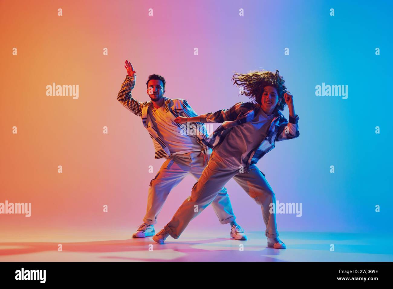 Dynamic shot of athletic man and woman, hip-hop dancers learning new ...