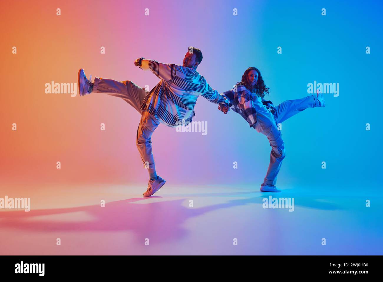 Talented and creative freestyle dancers performing in motion against ...
