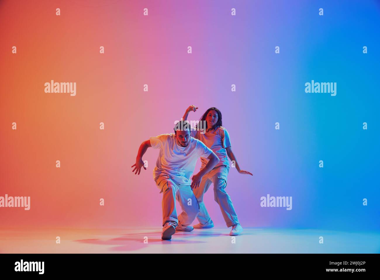 Dynamic lifestyle. Dancers performing hip hop, freestyle in neon lights ...