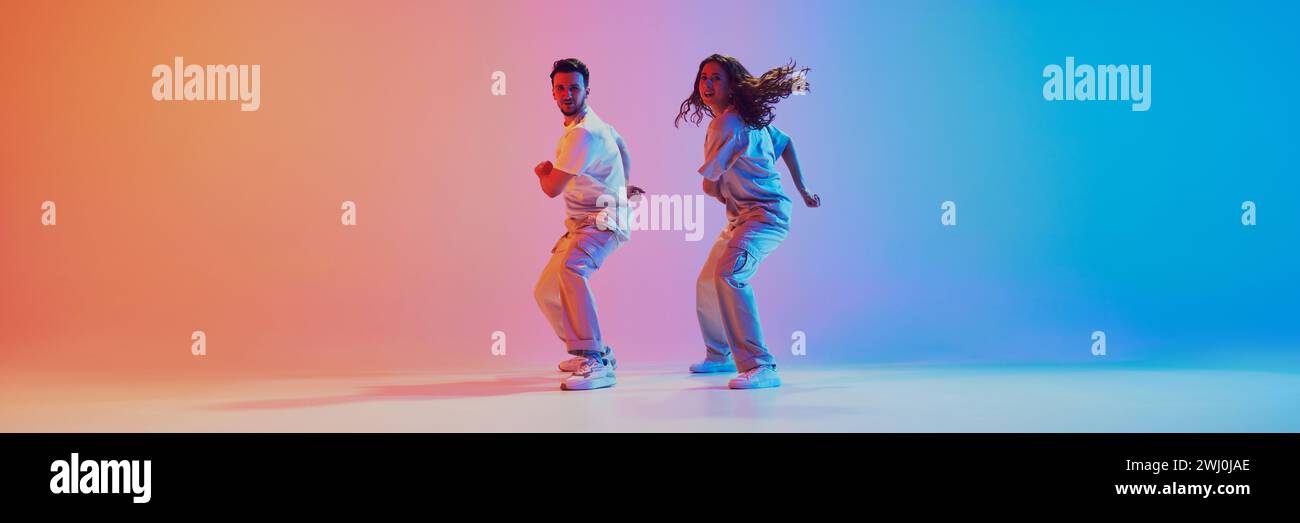 Banner. Dance duo dancing hip hop in motion against gradient t studio ...