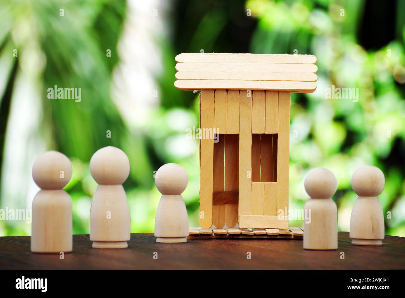 Miniature family house and wooden dolls. Concept of Protection and ...
