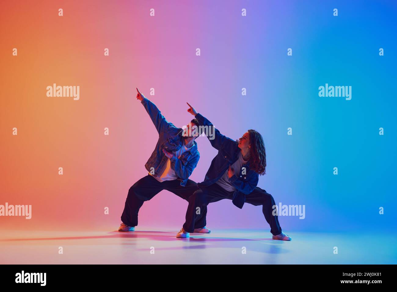 Dynamic shot of young, athletic male and female dancers dressed in ...